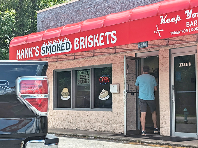 The bright red awning of Hank's stands out like a beacon for barbecue pilgrims, promising smoky salvation on Indianapolis's MLK Jr. Street.