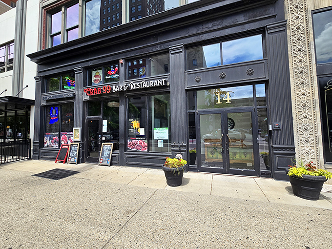 The glowing red "Crab 99" sign beckons like a lighthouse for seafood lovers, promising treasures from the sea in downtown Indianapolis.