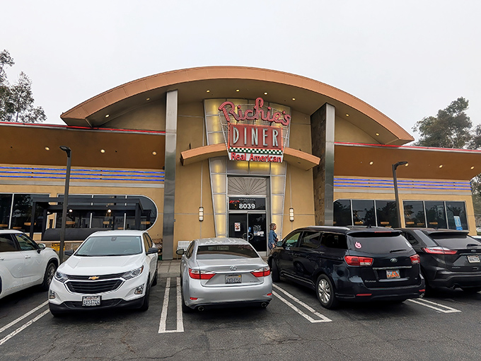 The curved, retro-modern facade of Richie's Diner beckons like a time machine disguised as a restaurant. Step inside and leave your diet at the door.
