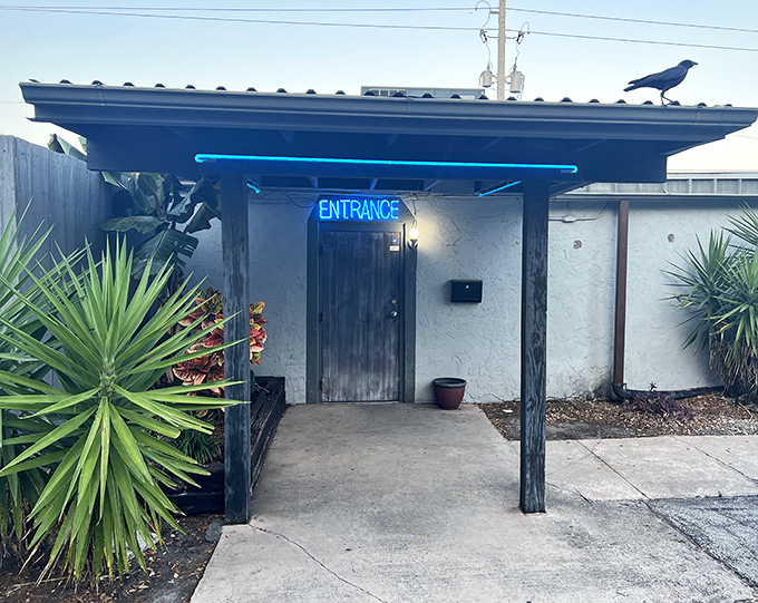 That blue neon "ENTRANCE" sign isn't just an invitation&mdash;it's a portal to steak paradise hiding behind an unassuming Florida facade.