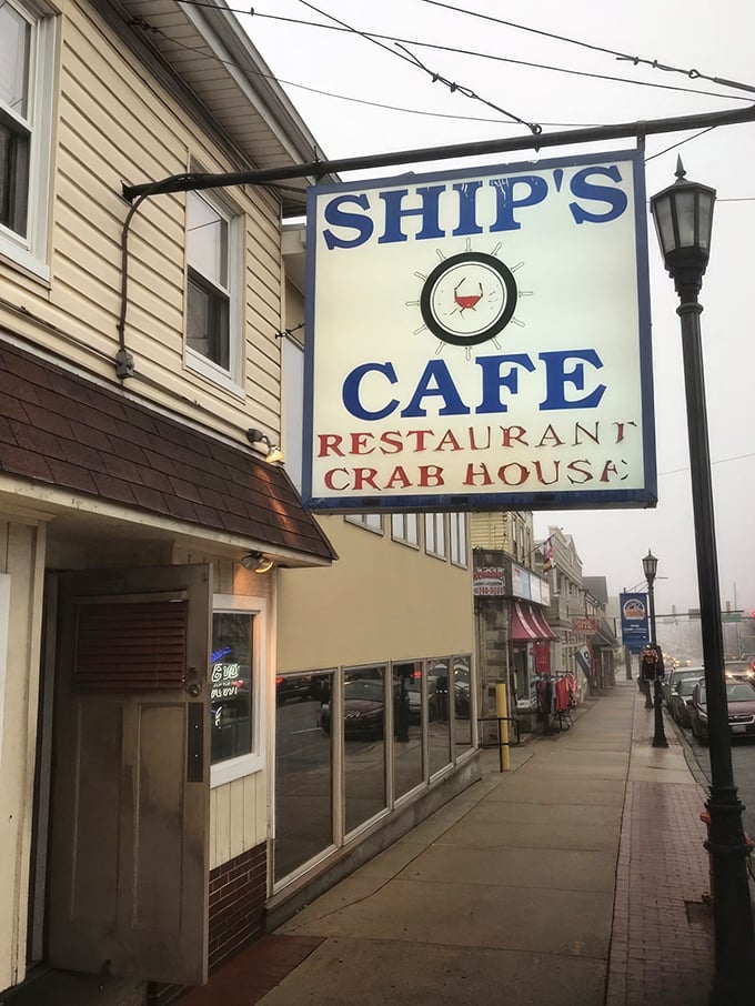 The iconic Ship's Cafe sign stands sentinel on Frederick Road, promising seafood treasures within. That red crab at the center knows what you're in for.