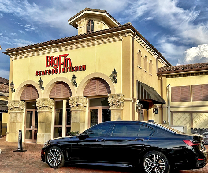 Mediterranean elegance meets Florida flair at Big Fin's inviting entrance. The warm lighting and arched doorways promise seafood adventures beyond the ordinary.