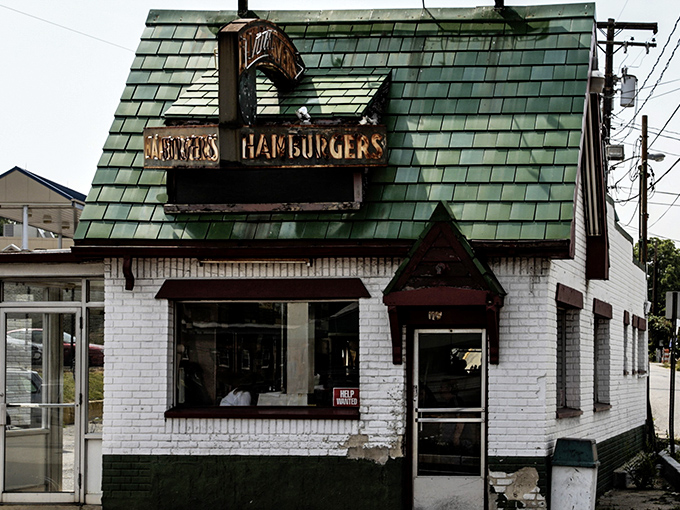 The iconic green-shingled roof and weathered "DONUTS HAMBURGERS" sign announce this Laurel institution without fanfare&mdash;architectural honesty at its most delicious.