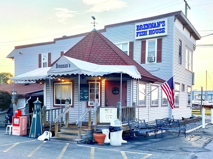 The unassuming exterior of Brennan's Fish House stands like a maritime sentinel in Grand River, complete with its iconic red-roofed turret and welcoming porch.