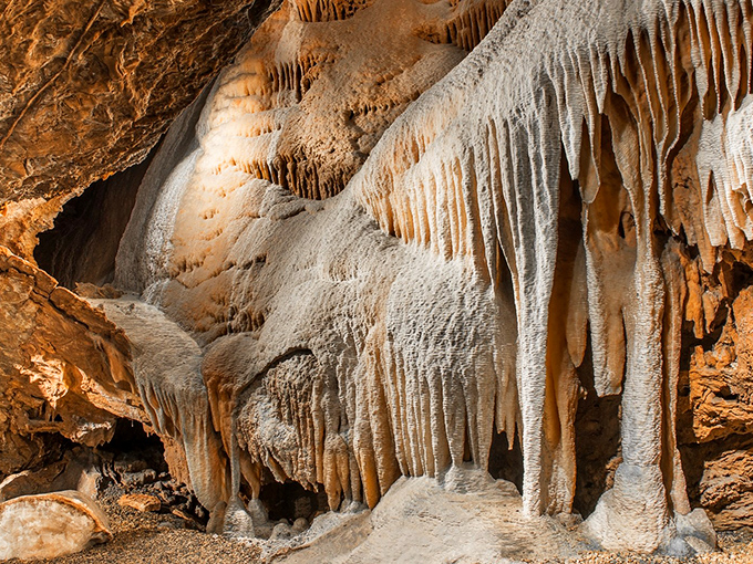 Nature's own sculpture gallery, where millions of years of dripping water created this otherworldly landscape of amber-hued formations.