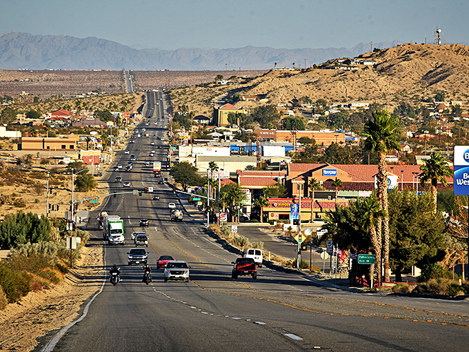 Palm trees stand like sentinels along Twentynine Palms Highway, where the desert sky puts on a better show than any streaming service you've subscribed to.