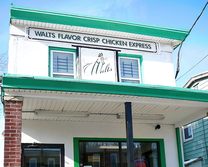 The iconic green and white exterior of Walt's Flavor Crisp Chicken Express stands as a beacon of fried chicken perfection in Wilmington.