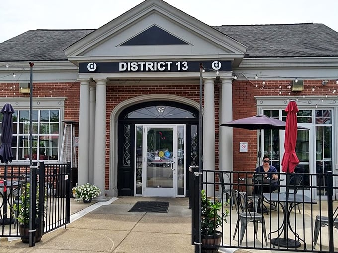 The architectural equivalent of a firm handshake – District 13's brick exterior with white columns promises small-town charm with big-city flavors waiting inside.