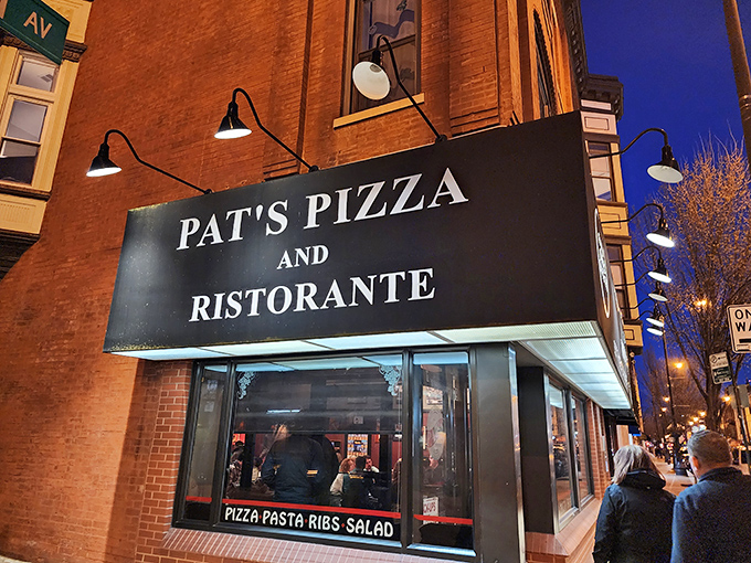 The iconic corner sign glows like a beacon for pizza pilgrims. Pat's Pizza & Ristorante stands proudly against the Chicago night sky.