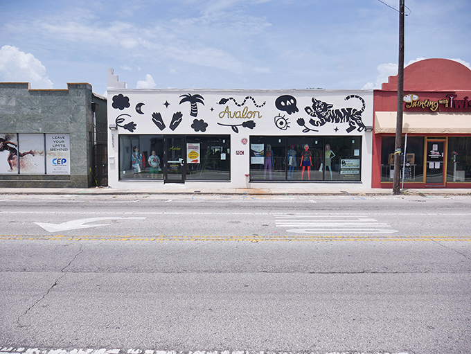 The whimsical storefront of Avalon Exchange beckons with playful murals and the promise of fashion treasures waiting to be discovered inside. 