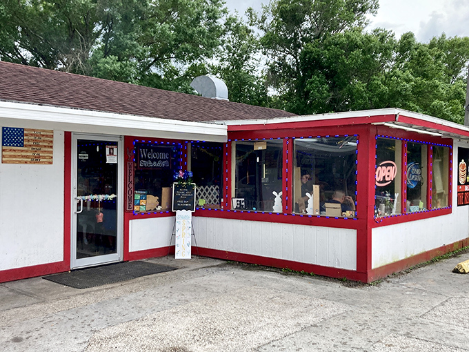 The iconic red-trimmed exterior of Red Top Pit Stop stands like a beacon for hungry travelers. This unassuming roadside gem promises comfort food paradise within.