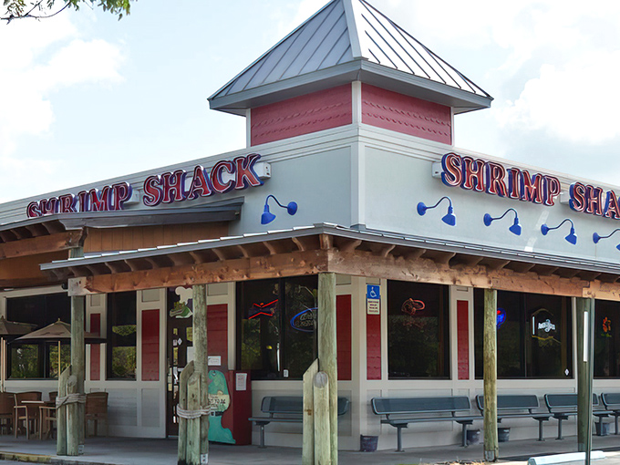The iconic red and white exterior of Shrimp Shack stands like a beacon of seafood salvation in Fort Myers. No pretension, just a promise of deliciousness awaiting inside.