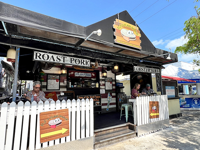 The white picket fence isn't keeping secrets in&mdash;that cartoon clam with googly eyes is practically winking at passersby, promising seafood magic within.