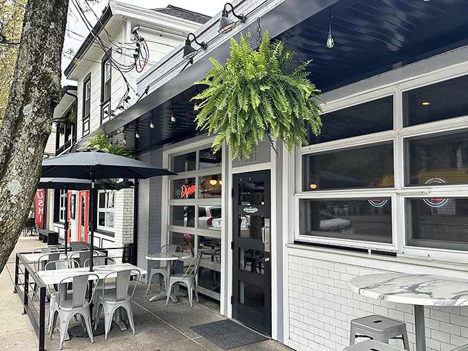 The Governor's inviting exterior beckons with lush hanging ferns and modern metal seating. Small-town charm meets contemporary dining at its finest.