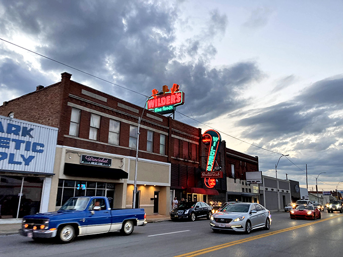 That neon sign isn't just advertising &ndash; it's a beacon of hope for hungry travelers. The vintage glow promises carnivorous delights await inside.