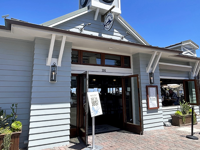 The crisp white exterior of Bluewater Avalon beckons like a maritime mirage, promising seafood treasures within its nautical-themed walls.