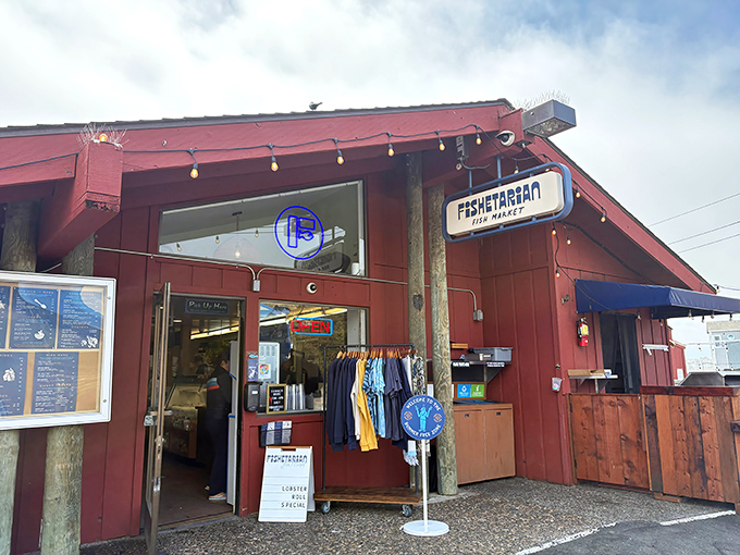 The unassuming red exterior of Fishetarian Fish Market, where that cheerful crab sign promises seafood treasures that outshine many white-tablecloth establishments along the coast.