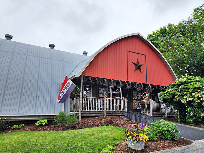 The iconic red barn exterior stands as a beacon of charm in Amish Country, promising treasures within its curved roof.