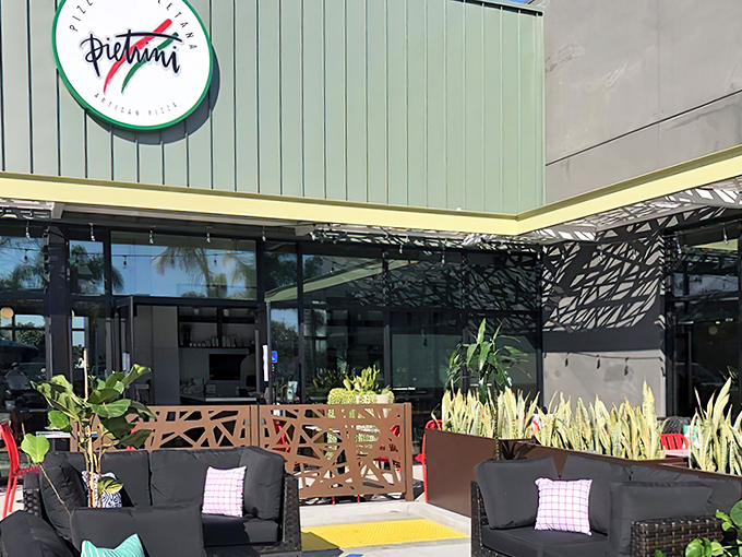 The unassuming exterior of Pietrini Pizza Napoletana proves once again that California's best culinary treasures often hide in plain sight, surrounded by pampas grass and promise.