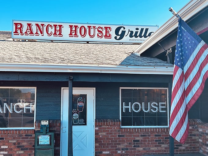 The American flag waves a hearty welcome outside Ranch House Grille, where breakfast dreams come true beneath that unassuming Arizona sky.