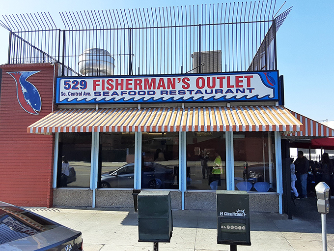 The seafood promised land awaits! Fisherman's Outlet's vibrant red umbrellas beckon hungry patrons like maritime flags signaling "fresh catch ahead."