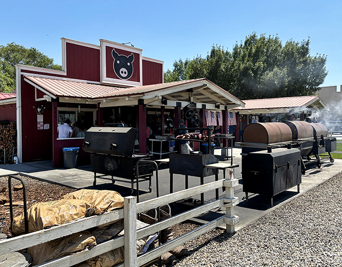 The iconic red building with its black pig logo stands as a beacon of barbecue excellence against the stunning Eastern Sierra backdrop.
