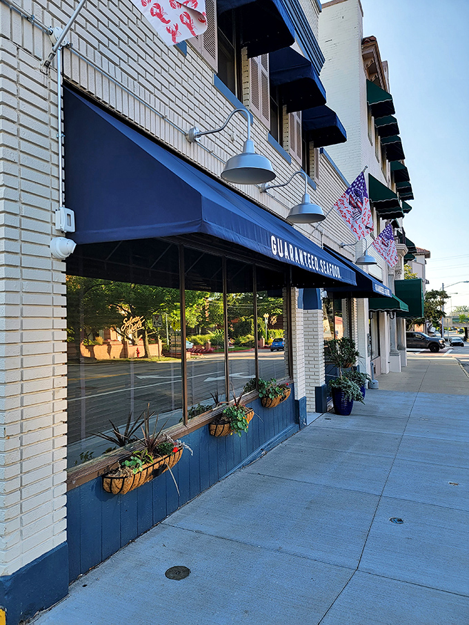The distinctive navy blue awning signals your arrival at coastal paradise, even in landlocked Ohio. Those flower baskets aren't just pretty&mdash;they're your first hint of the attention to detail waiting inside.