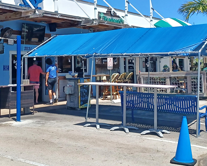The unassuming blue facade of The Whale's Rib hides culinary treasures within, like a pirate's chest disguised as a beach shack.