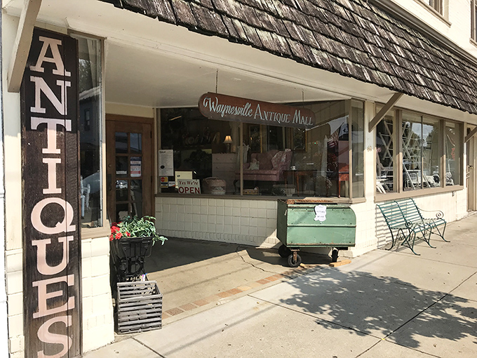 The unassuming entrance belies the wonderland within. Like a time portal disguised as a storefront, Waynesville Antique Mall beckons treasure hunters with promises of discovery.
