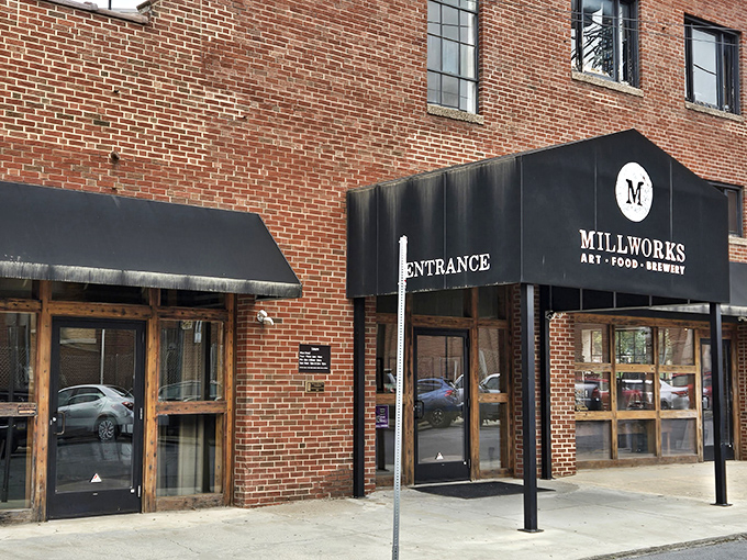 The unassuming brick exterior of The Millworks belies the culinary wonderland within. Like finding a secret door to Narnia, but with better pizza.