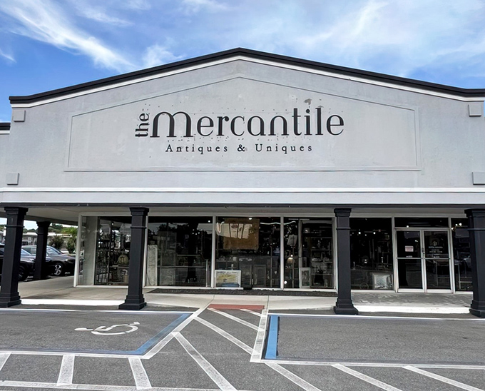The white facade gleams like a treasure chest in the Florida sun, palm trees standing guard at the entrance to vintage paradise.