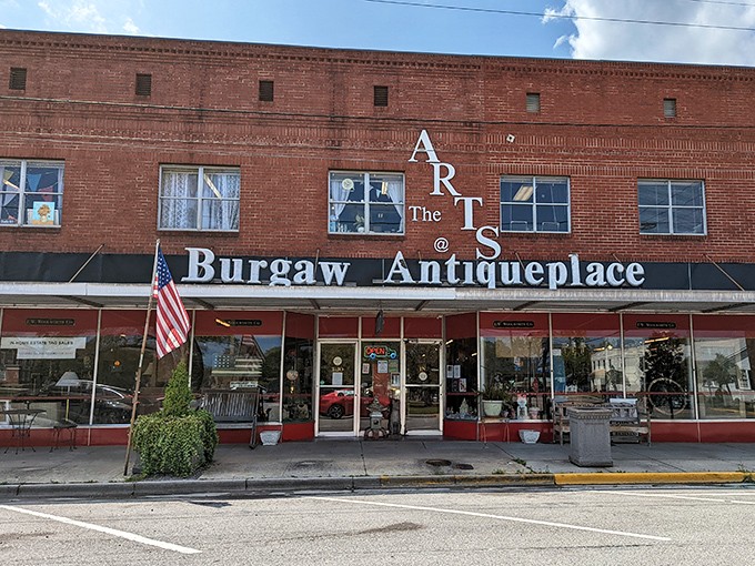 The iconic red brick fa&ccedil;ade of Burgaw Antique Place stands as a time portal in downtown Burgaw, inviting curious souls to step back through the decades.