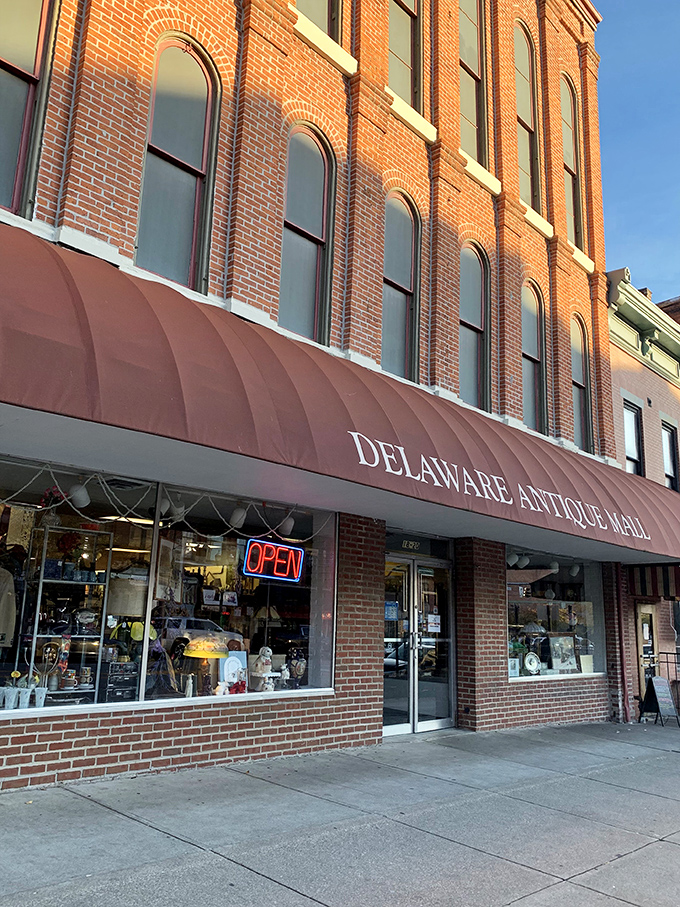 The iconic burgundy awning of Delaware Antique Mall beckons treasure hunters into this historic brick building, where the past awaits rediscovery.