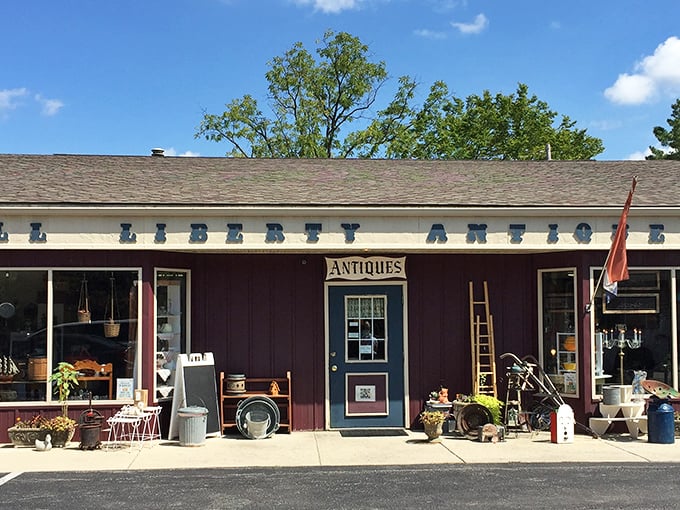 The unassuming burgundy exterior of Powell Liberty Antique Mall hides a universe of treasures inside, like a time-travel portal disguised as a country store.