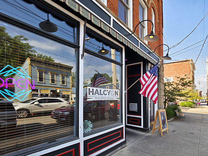 The historic brick fa&ccedil;ade of Harbor Halcyon welcomes visitors with classic charm and an American flag, promising culinary adventures in Ashtabula Harbor.