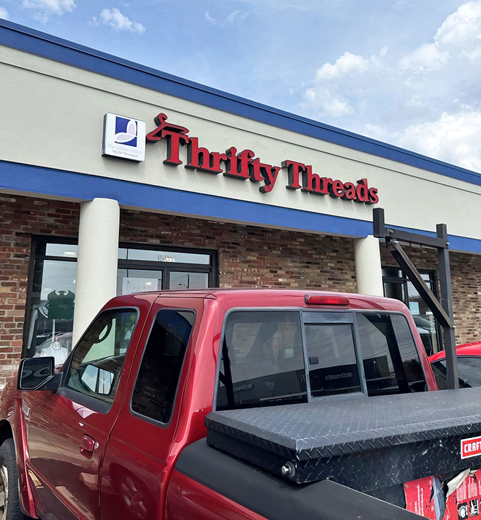 The iconic red signage of Thrifty Threads beckons like a lighthouse for bargain hunters navigating the sea of retail mediocrity.