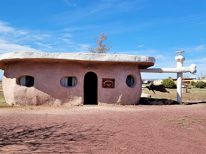 Fred Flintstone would feel right at home at this whimsical entrance, where prehistoric charm meets Route 66 kitsch in spectacular fashion.