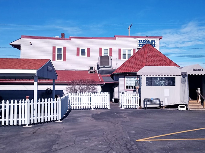 Brennan's Fish House stands proudly with its distinctive red-roofed gazebo entrance, like a lighthouse beckoning hungry seafood lovers to safe harbor.