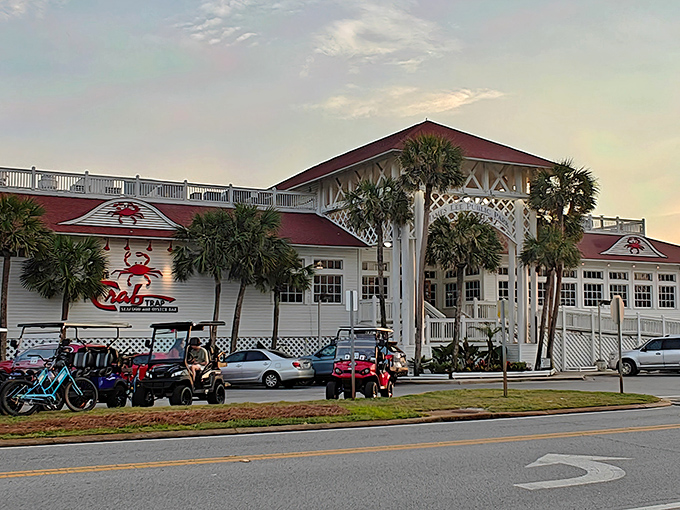 The Crab Trap stands proudly against the Florida sky, its red roof and iconic crab logo beckoning seafood lovers like a lighthouse for hungry souls.