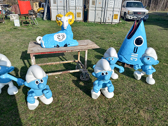 A blue ram with golden horns holds court over a gathering of Smurfs. Childhood nostalgia meets roadside whimsy in this delightfully odd tableau.