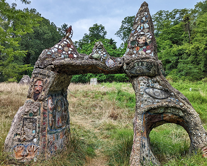 The magnificent Folk Arch stands like a portal to another dimension, its stone and concrete surface adorned with faces, symbols, and found objects that tell mysterious stories.