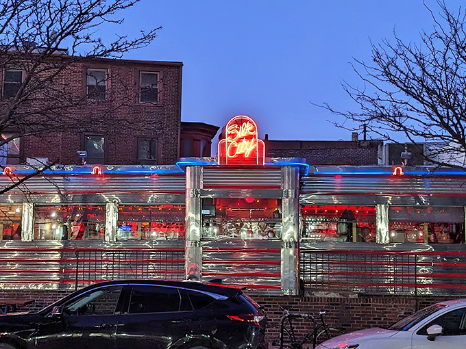 That neon glow against the twilight sky isn't just a sign—it's a beacon calling hungry souls to food nirvana.