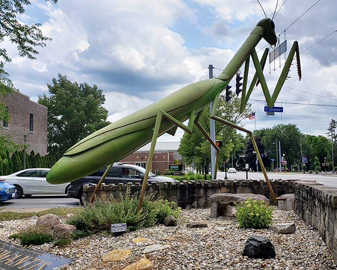 The KokoMantis stands tall against the Indiana sky, like a lime-green sentinel guarding downtown Kokomo with its otherworldly presence.