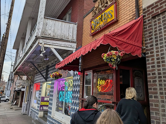That red awning beckons like a culinary lighthouse, promising hot dog adventures beyond your wildest dreams.