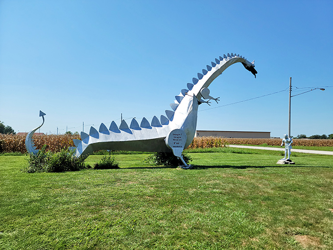 Behold the Kaskaskia Dragon in all its metallic glory, standing sentinel over Illinois farmland like a medieval fever dream.