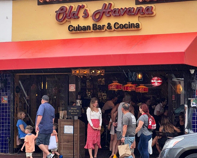 The yellow facade of Old's Havana beckons like a warm tropical embrace, promising authentic Cuban flavors on Miami's vibrant Calle Ocho.