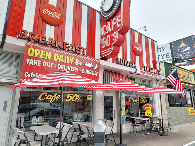 The time machine disguised as a diner. Cafe 50's vibrant red and white striped exterior beckons with promises of nostalgic delights and all-day breakfast.