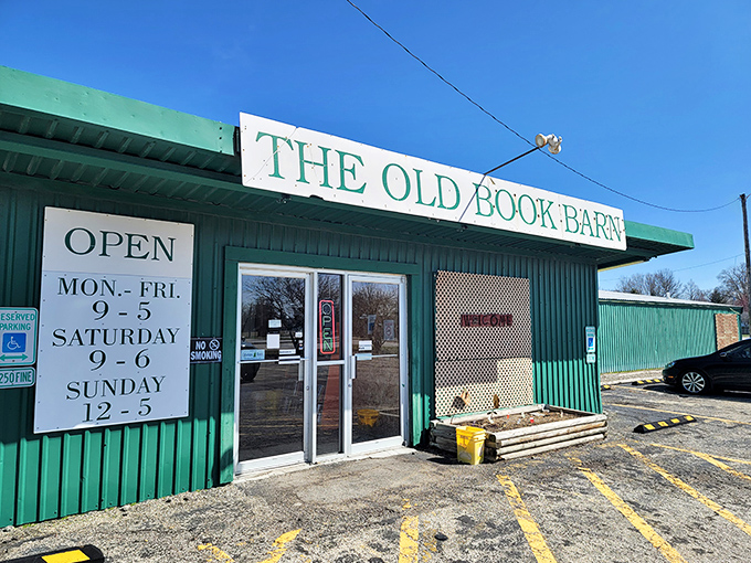 The green exterior of The Old Book Barn stands like a literary oasis in Forsyth, proudly announcing its treasures with a no-nonsense sign and welcoming entrance.