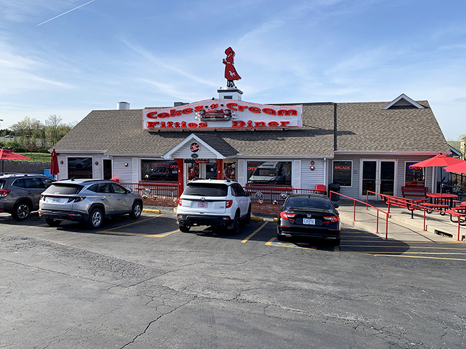 The red-dressed carhop silhouette on the roof isn't waving hello—she's signaling to time travelers that they've successfully reached the 1950s.