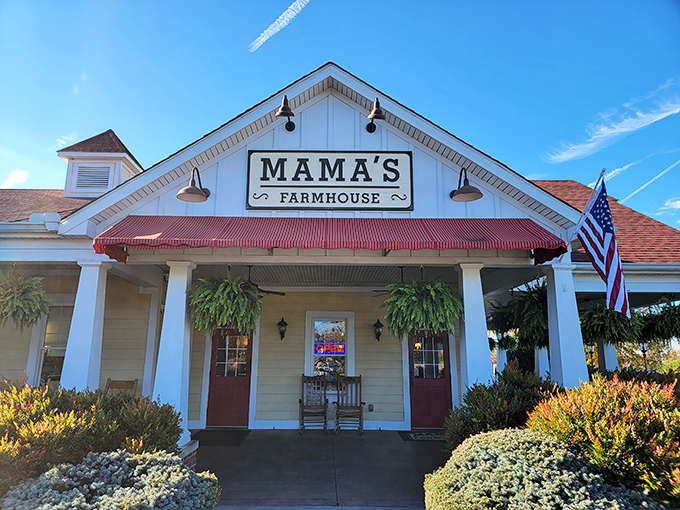 The classic white farmhouse exterior with its red-trimmed awning isn't just inviting—it's practically hollering "Come get some comfort food, y'all!"